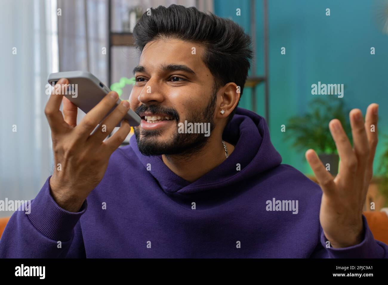 Happy excited indian man making online phone call conversation with ...