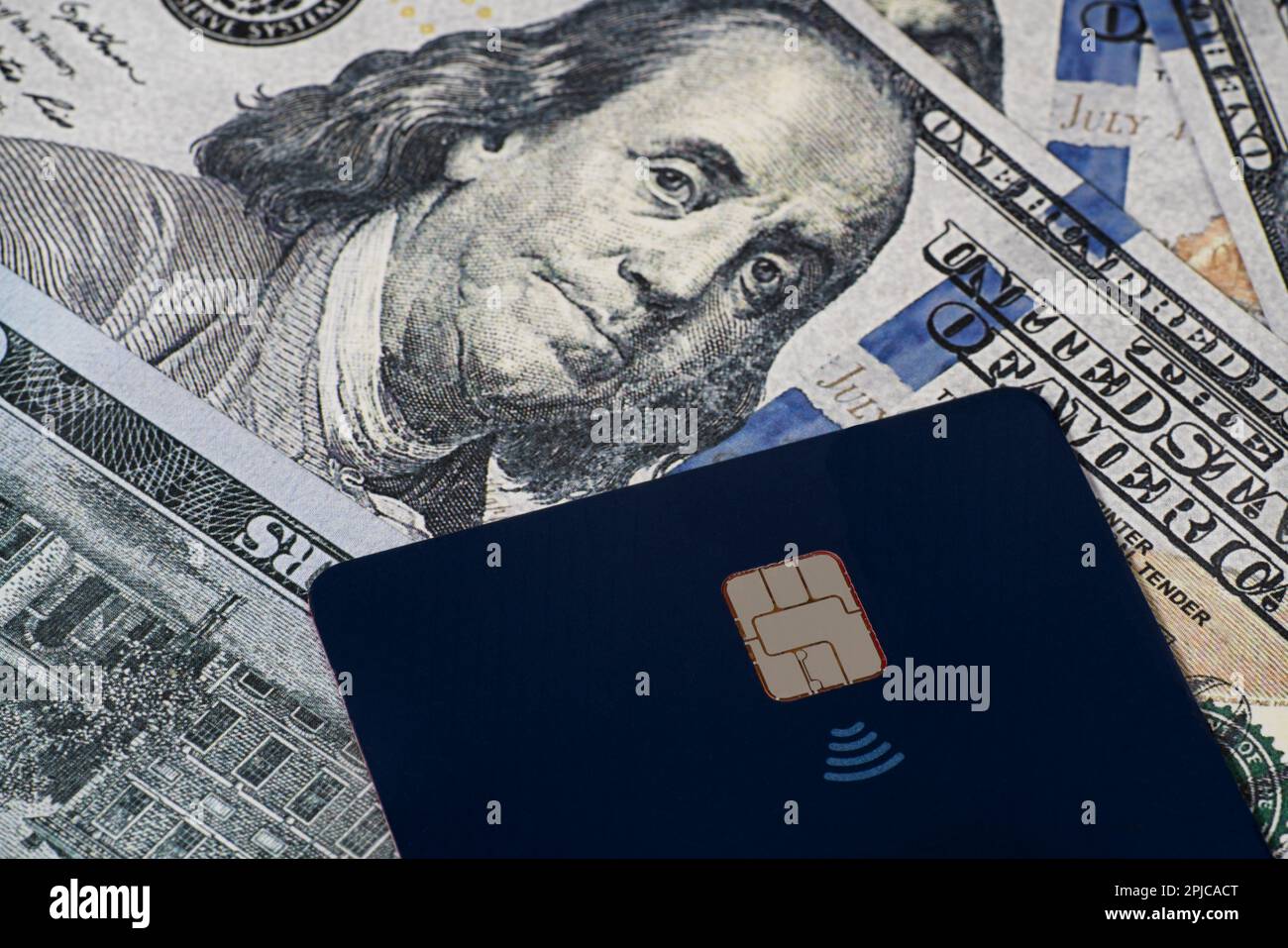 Credit card on US 100 dollar banknote with chip Stock Photo - Alamy