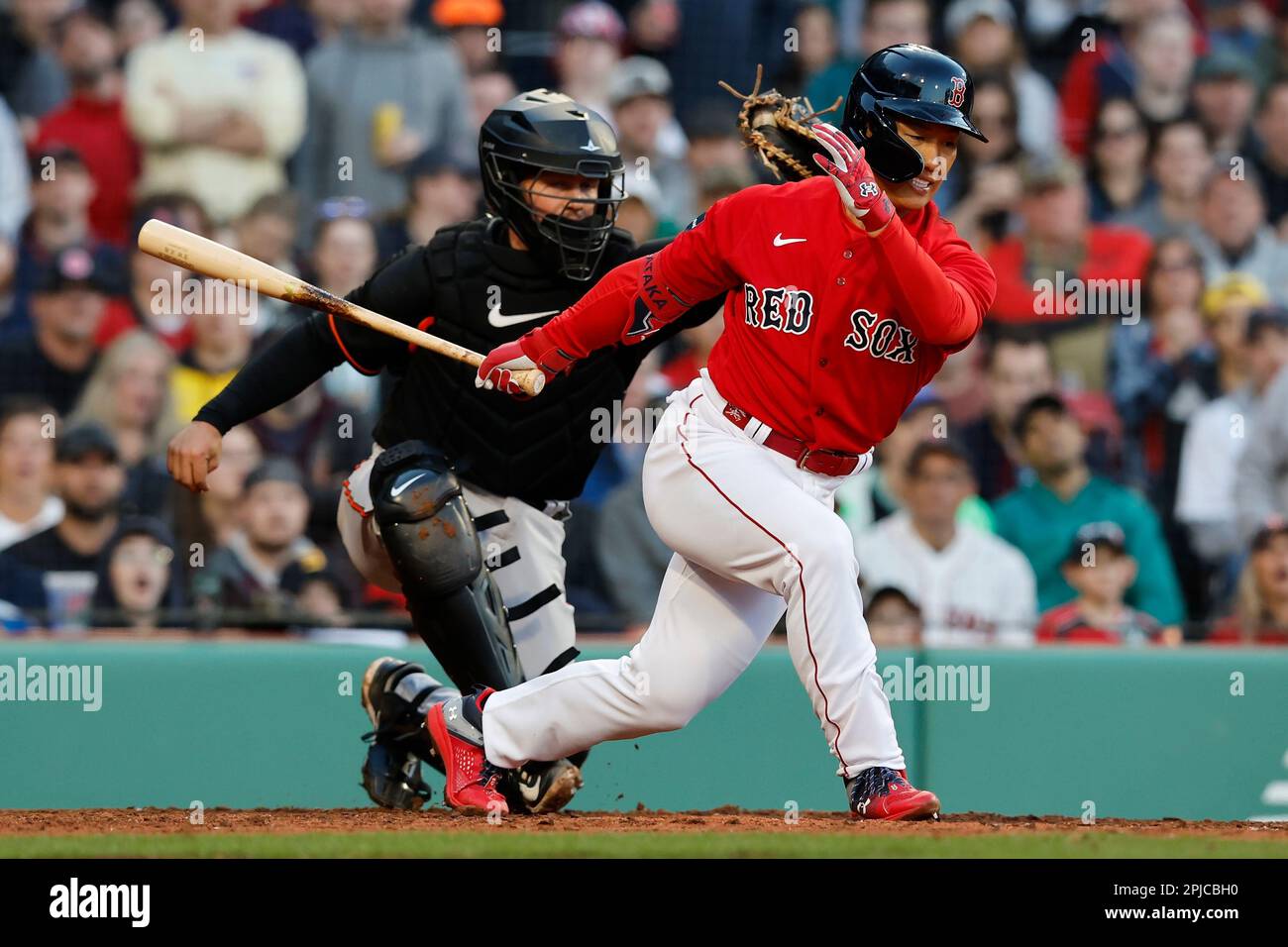 Boston Red Sox's Masataka Yoshida, right, strikes out swinging in front of Baltimore Orioles ...