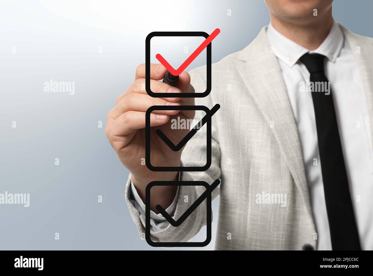 Man pointing at red check mark in box on virtual screen, closeup Stock ...