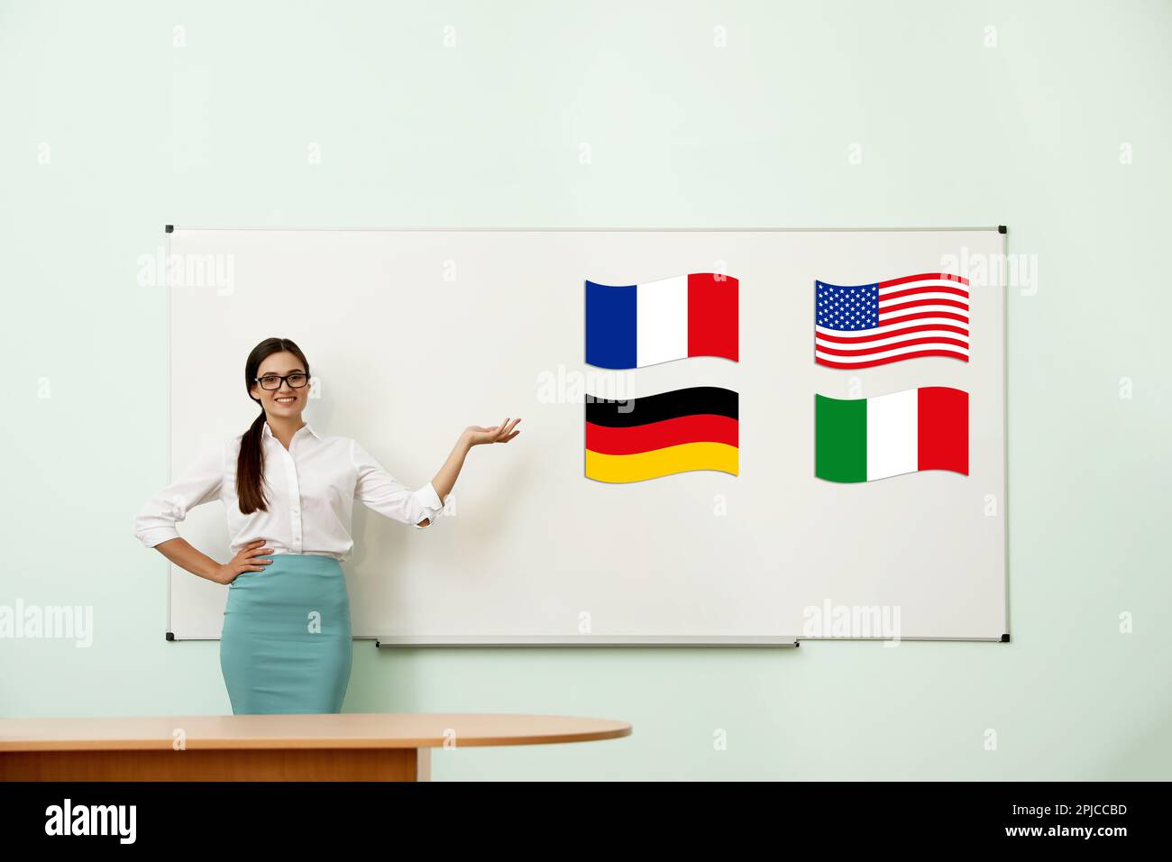 Foreign languages teacher near whiteboard with different flags in ...