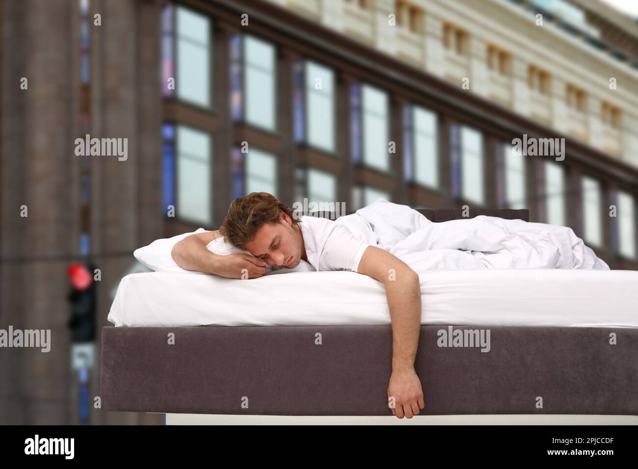 Man sleeping in bed and beautiful view of building on background. Good ...