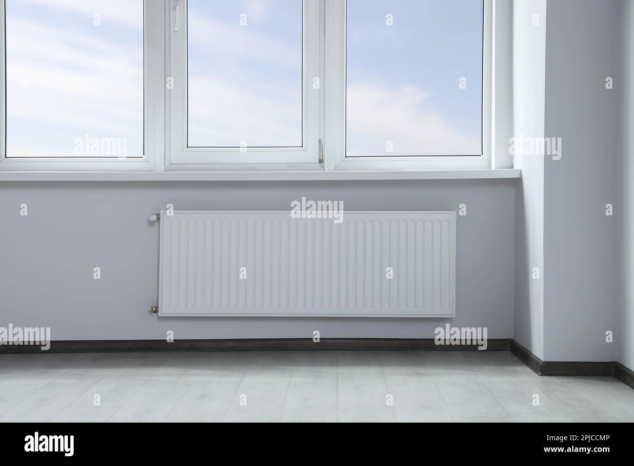 Modern office with window and radiator. Interior design Stock Photo - Alamy
