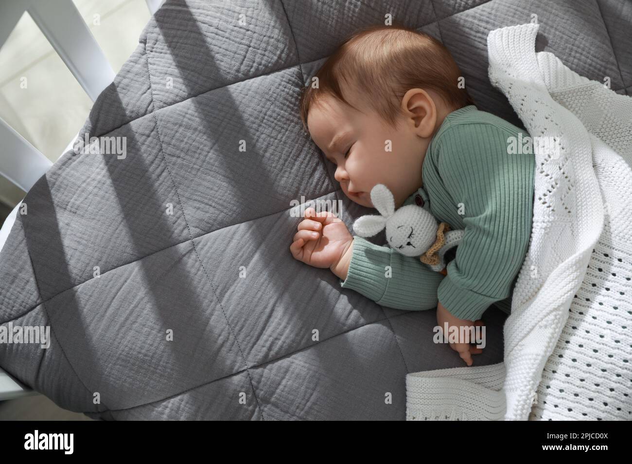 Cute little baby sleeping in crib, top view. Space for text Stock Photo ...