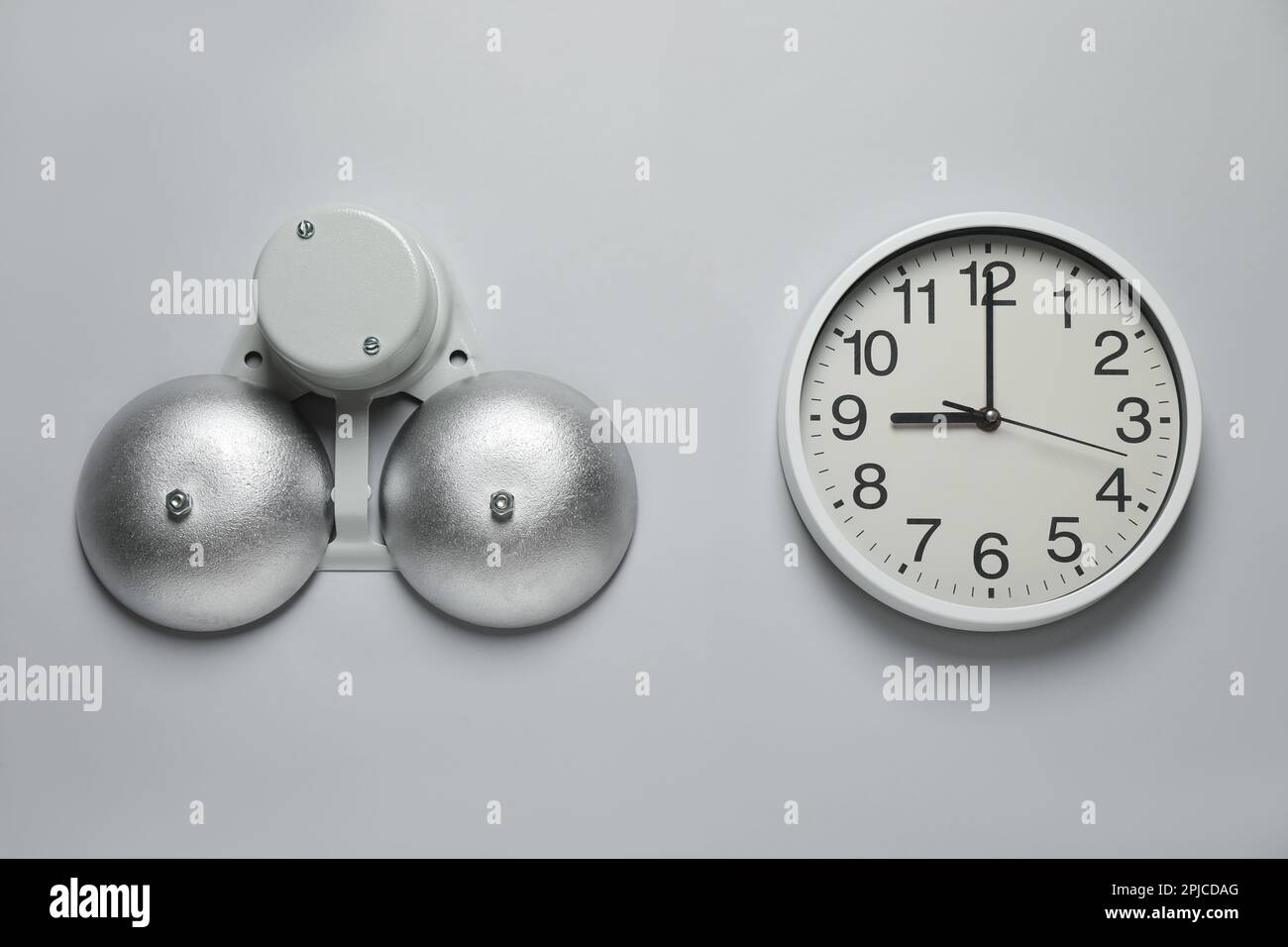 Modern electrical school bell and clock on white wall Stock Photo - Alamy