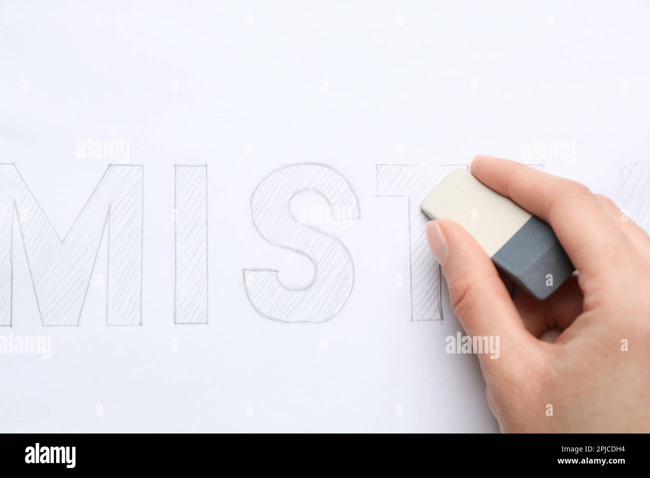 Woman erasing word on sheet of white paper, top view Stock Photo - Alamy