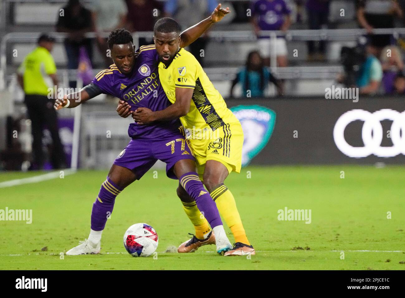 Nashville SC's Shaq Moore, right, wraps his arms around Orlando City's ...