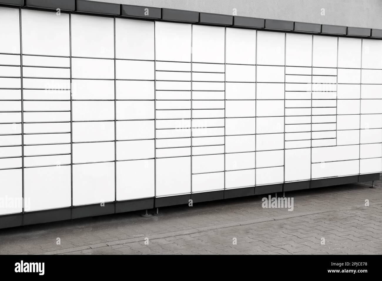 Modern parcel locker with many postal boxes outdoors Stock Photo - Alamy