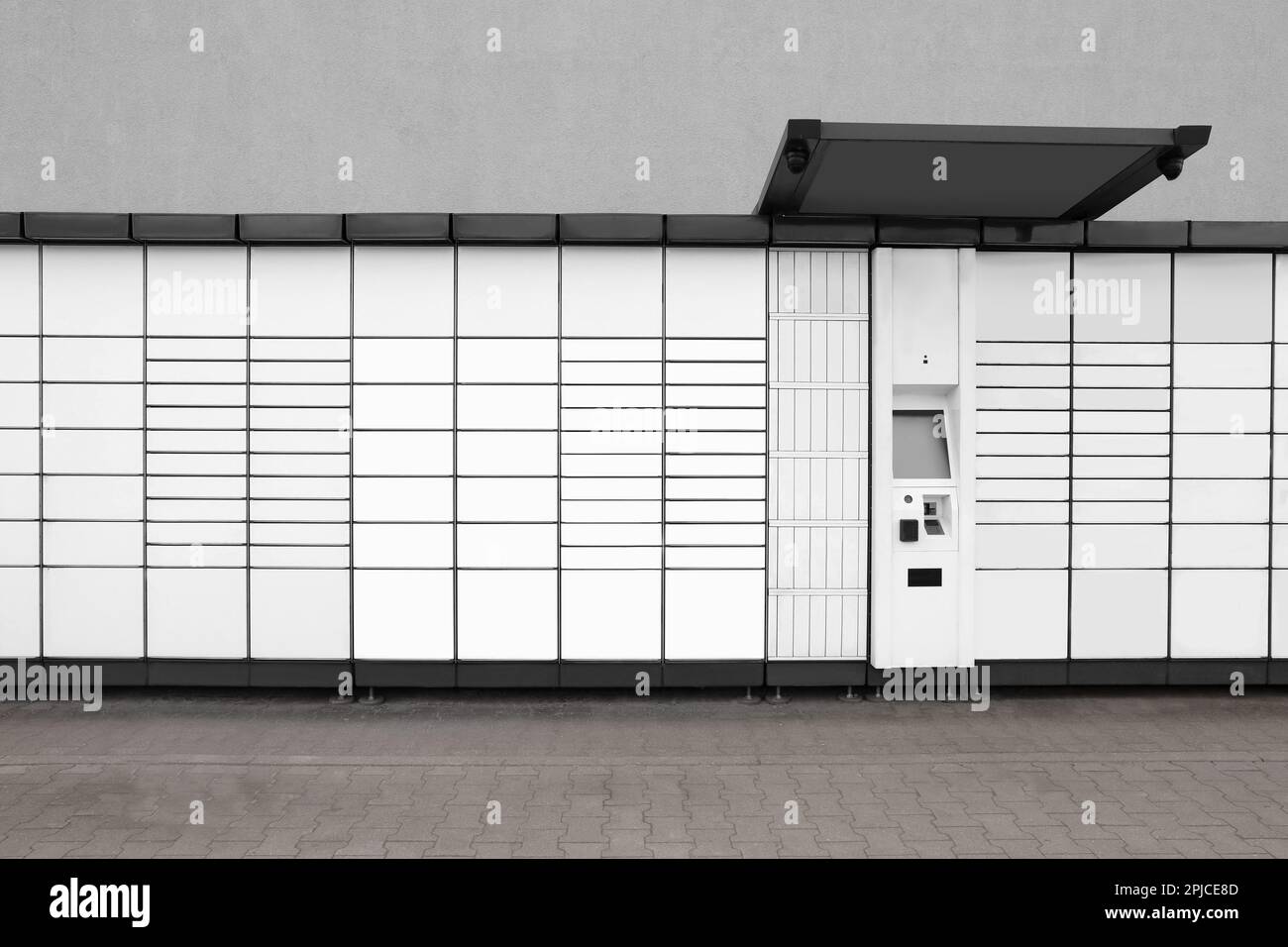 Modern parcel locker with many postal boxes outdoors Stock Photo - Alamy