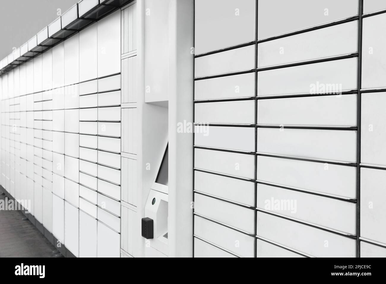 Modern parcel locker with many postal boxes Stock Photo - Alamy