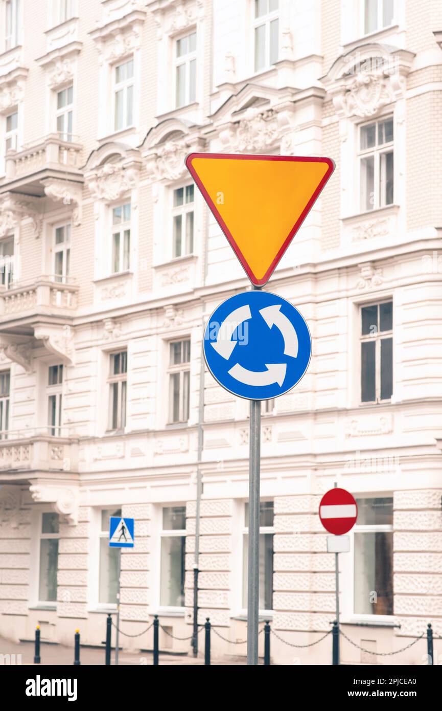 Post with Roundabout and Yield road signs on city street Stock Photo ...