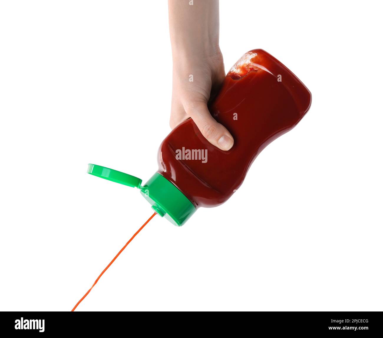 Woman pouring tasty ketchup from bottle on white background, closeup ...