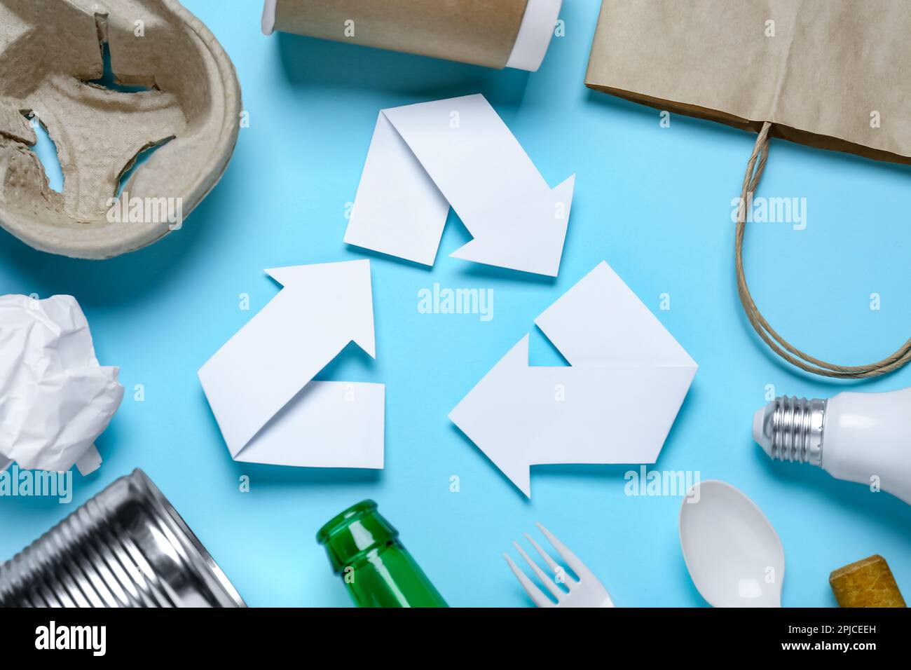 Recycling symbol and garbage on light blue background, flat lay Stock ...