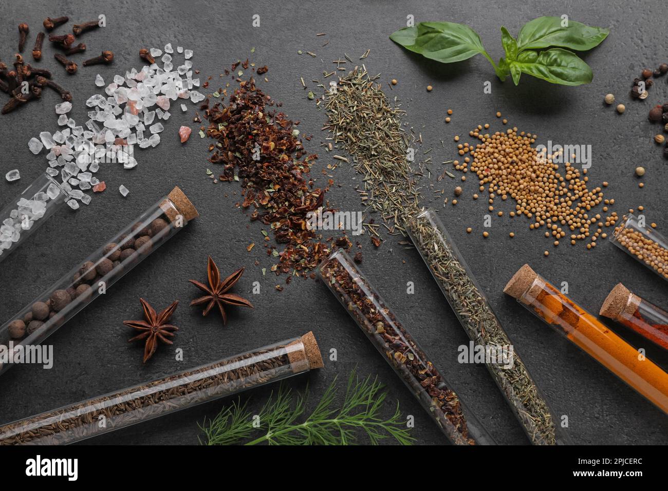 Flat lay composition with various spices, test tubes and fresh herbs on ...