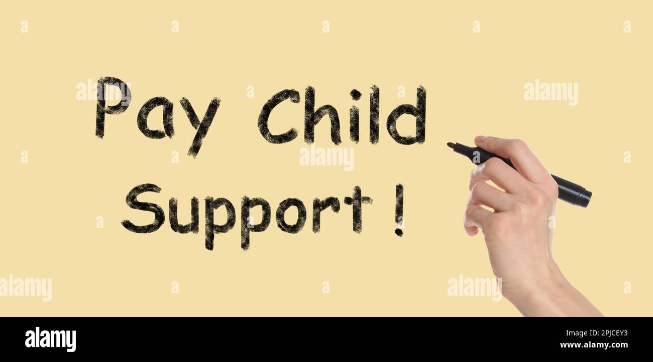 Woman with marker and phrase PAY CHILD SUPPORT! on beige background ...