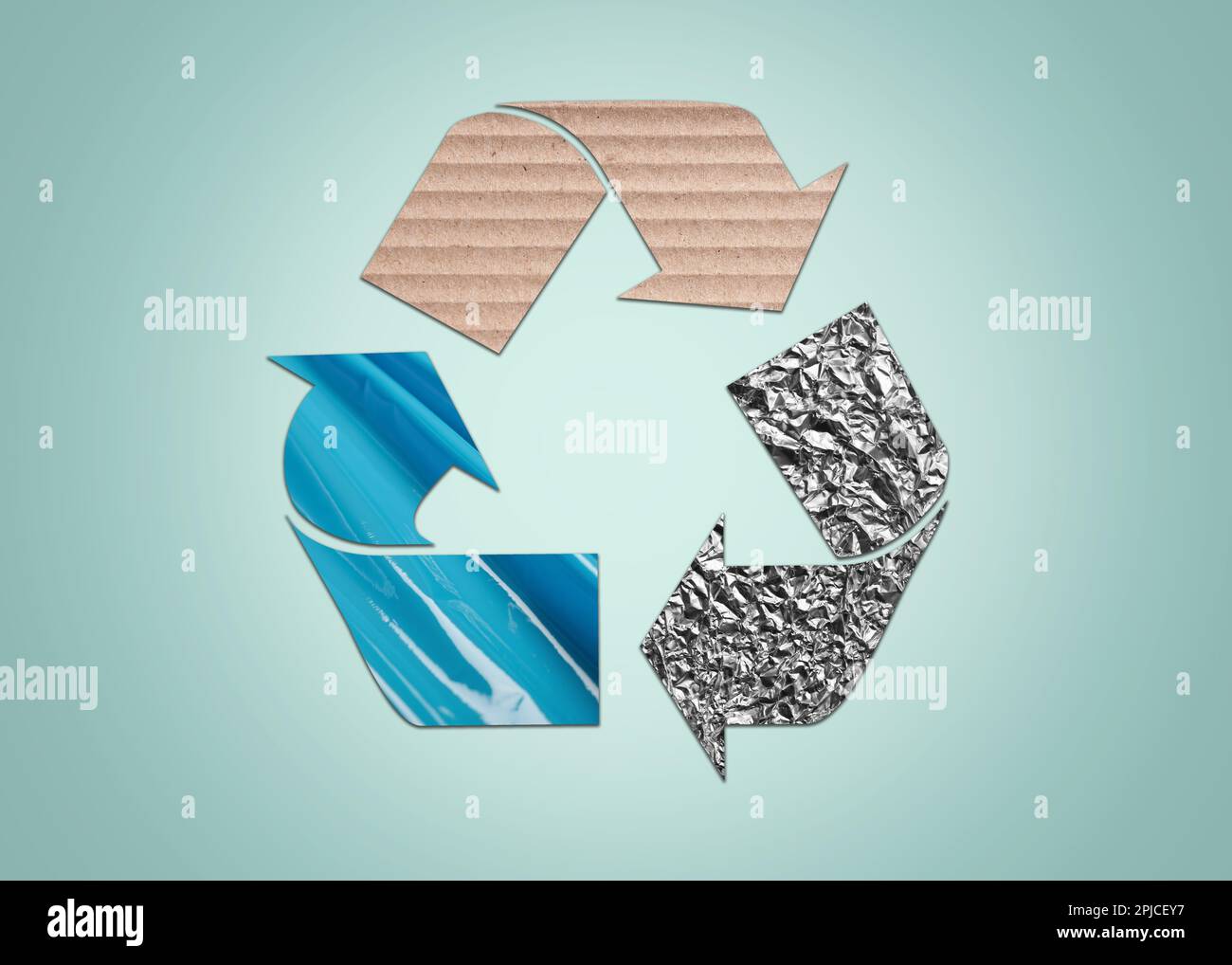 Recycling symbol made of crumpled foil, cardboard and turquoise stretch ...