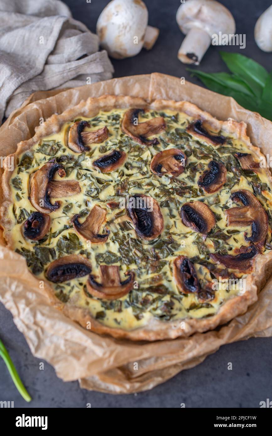 home made quiche with wild garlic on a table Stock Photo - Alamy