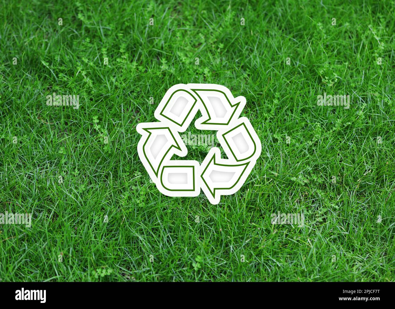 Green grass and illustration of recycling symbol Stock Photo - Alamy