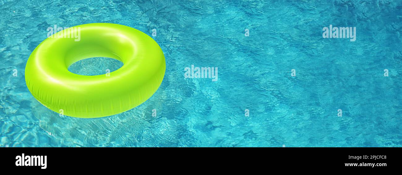 Bright inflatable ring floating in swimming pool on sunny day, space ...