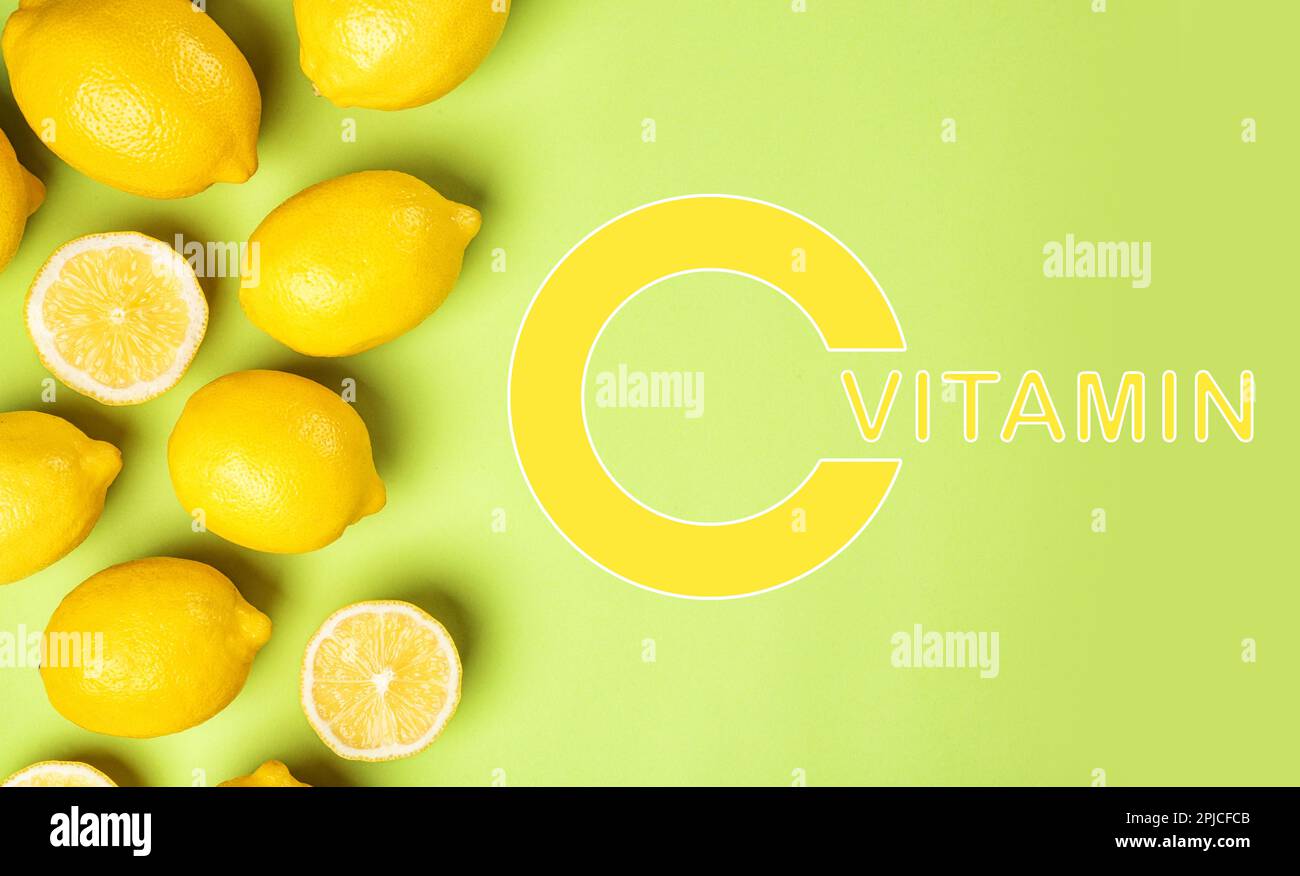 Source of Vitamin C. Flat lay composition with whole and sliced lemons ...