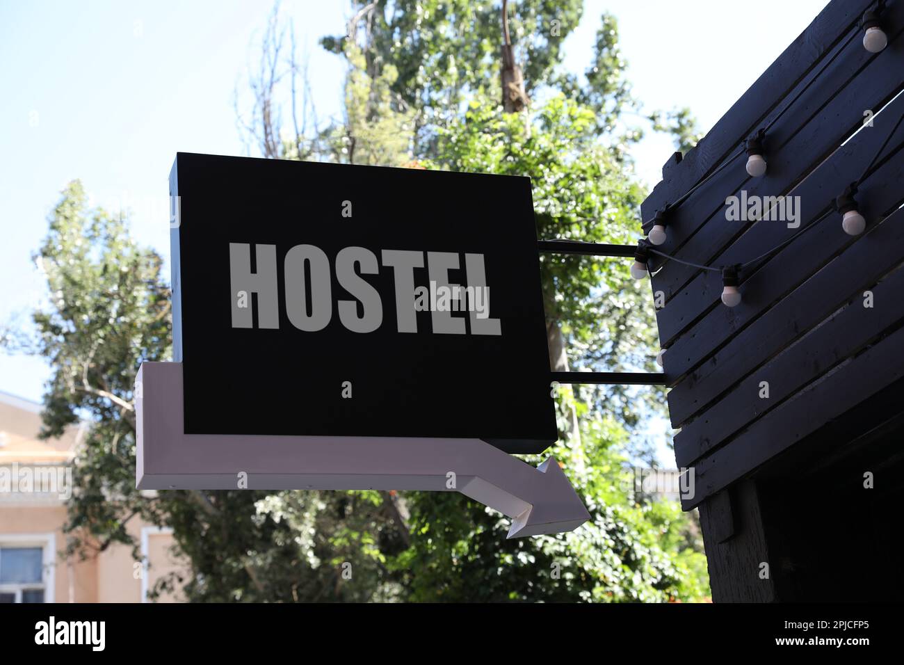 HOSTEL sign board with arrow on building outdoors Stock Photo - Alamy