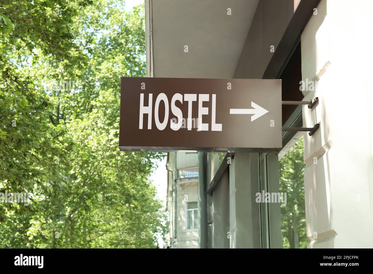 HOSTEL lightbox signage with arrow on building wall outdoors Stock ...