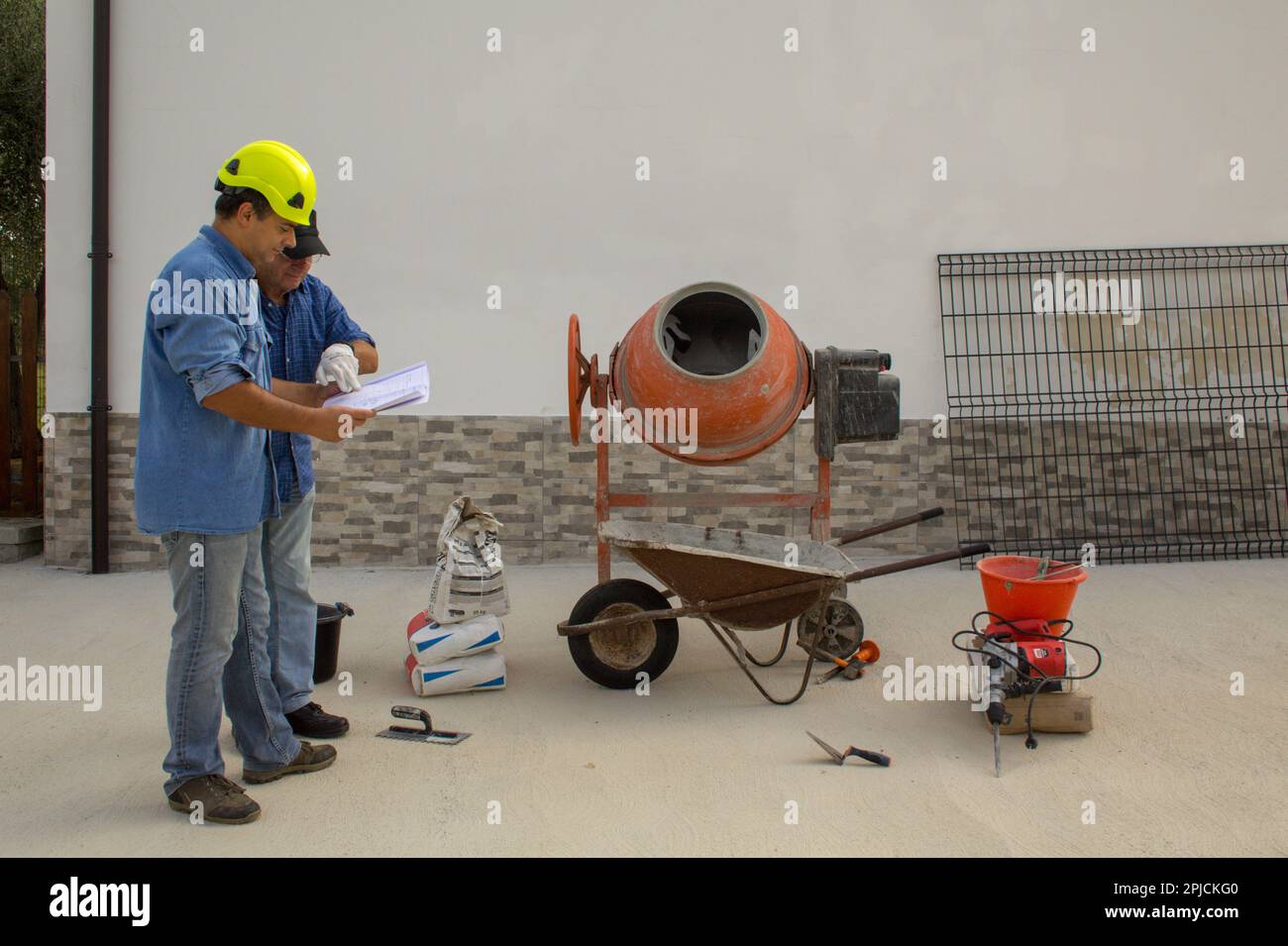 Image of a couple of construction workers on a construction site while ...