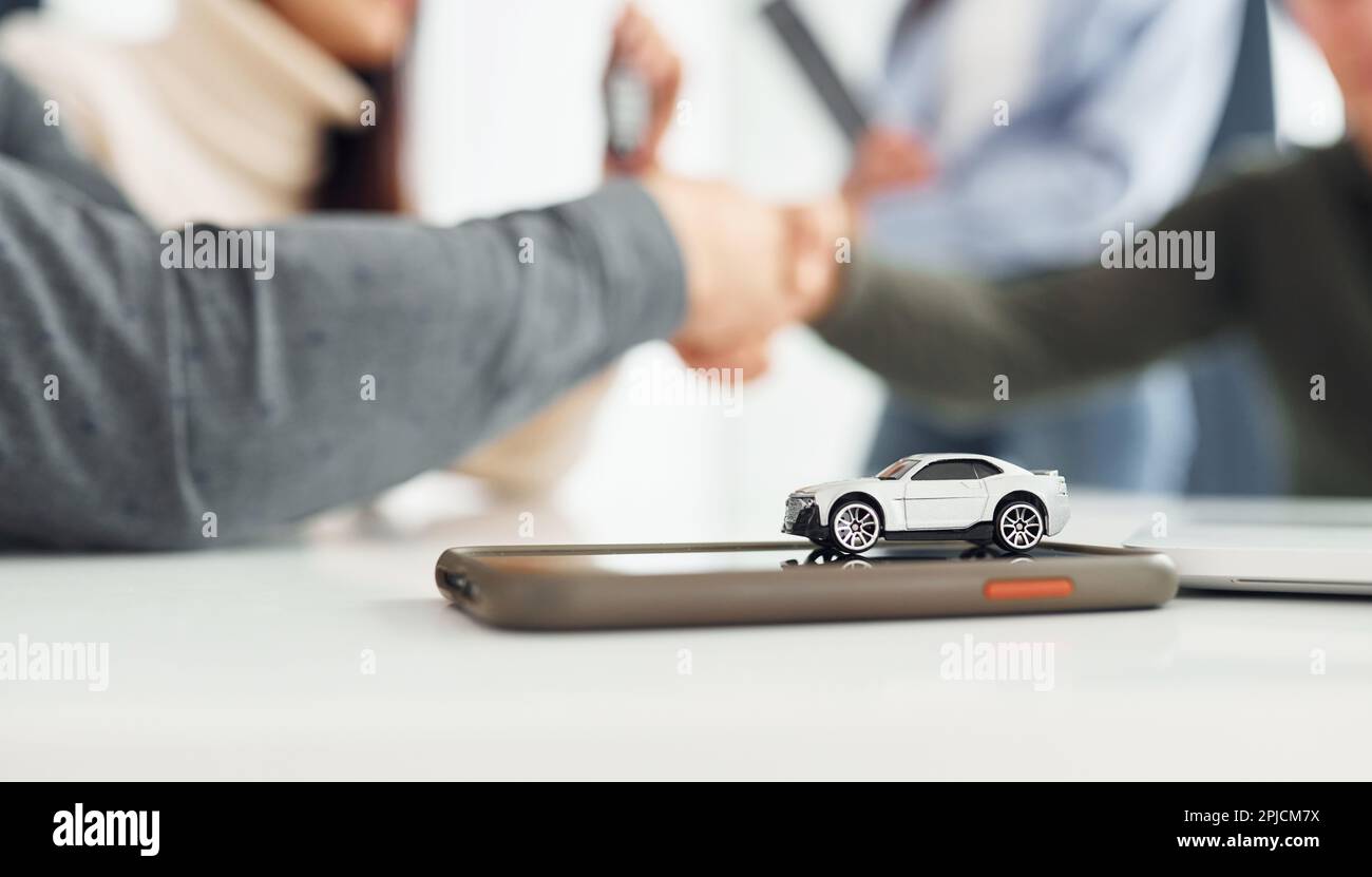 Doing handshake. Group of people works in the office by sitting by the ...