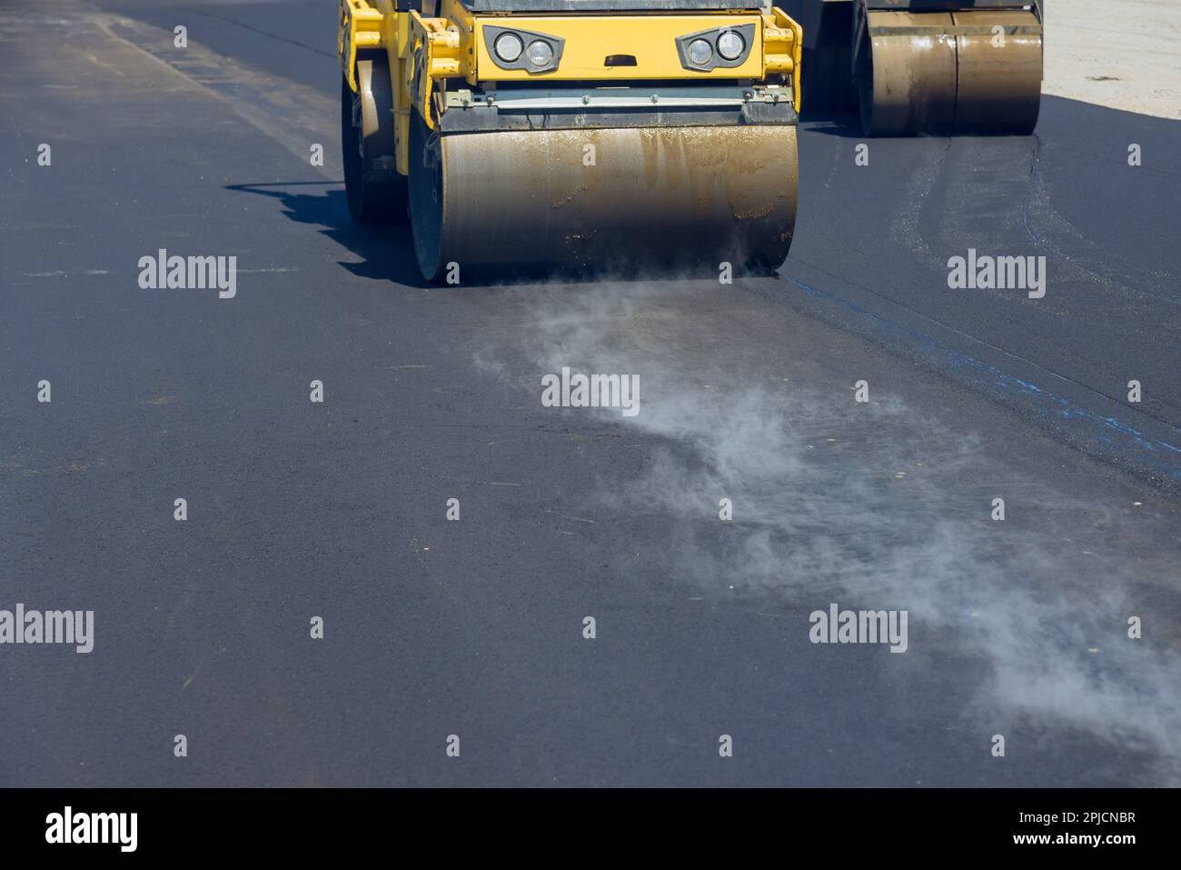 During vibratory road roller compactor process construction worker is ...