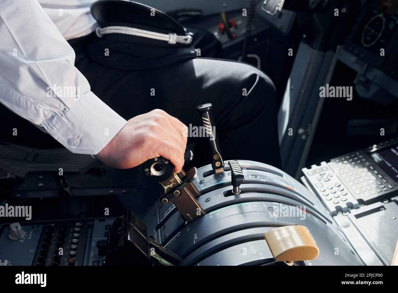 Side view. Pilot in formal wear sits in the cockpit and controls ...