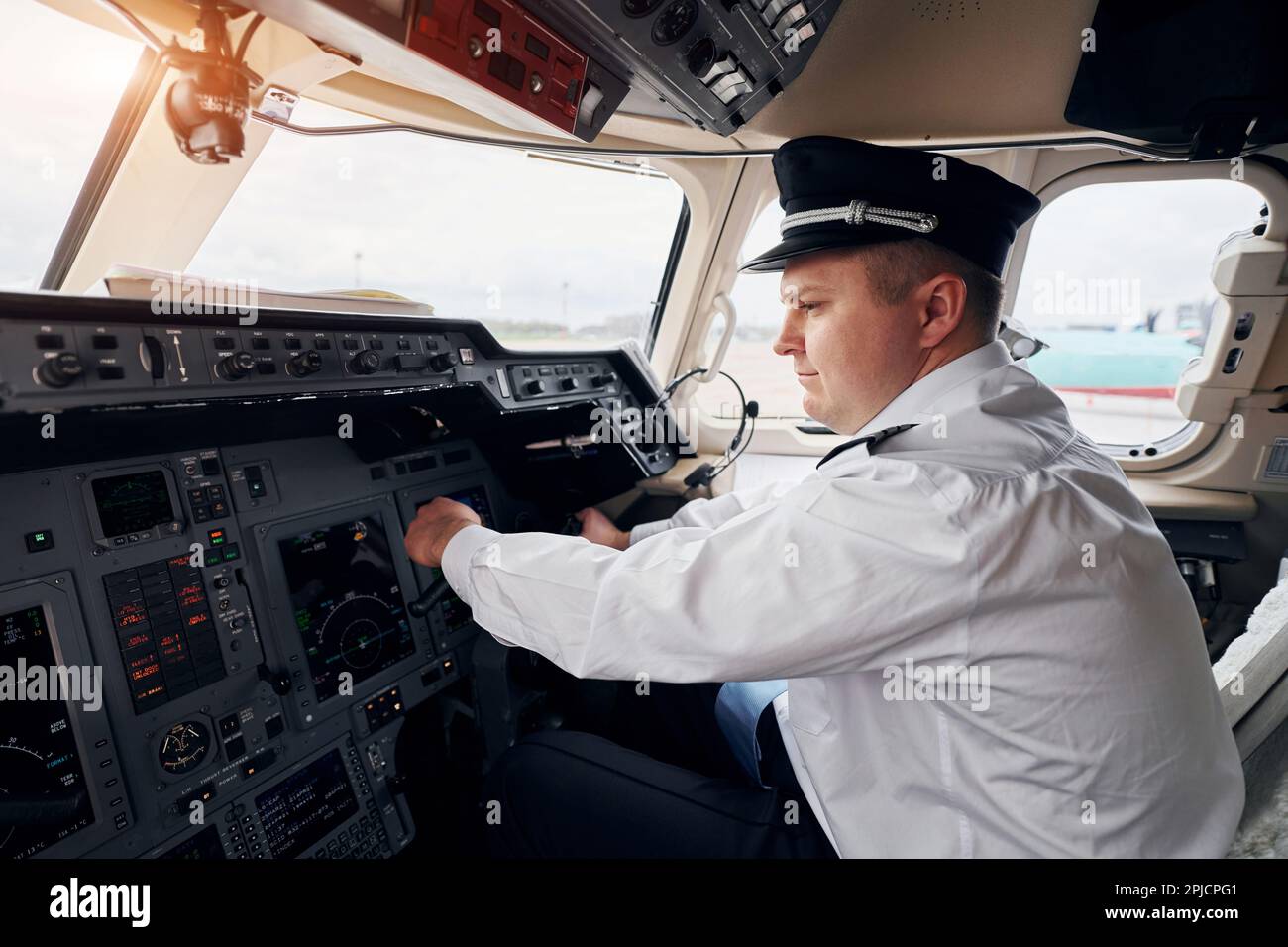 Professional worker. Pilot in formal wear sits in the cockpit and ...