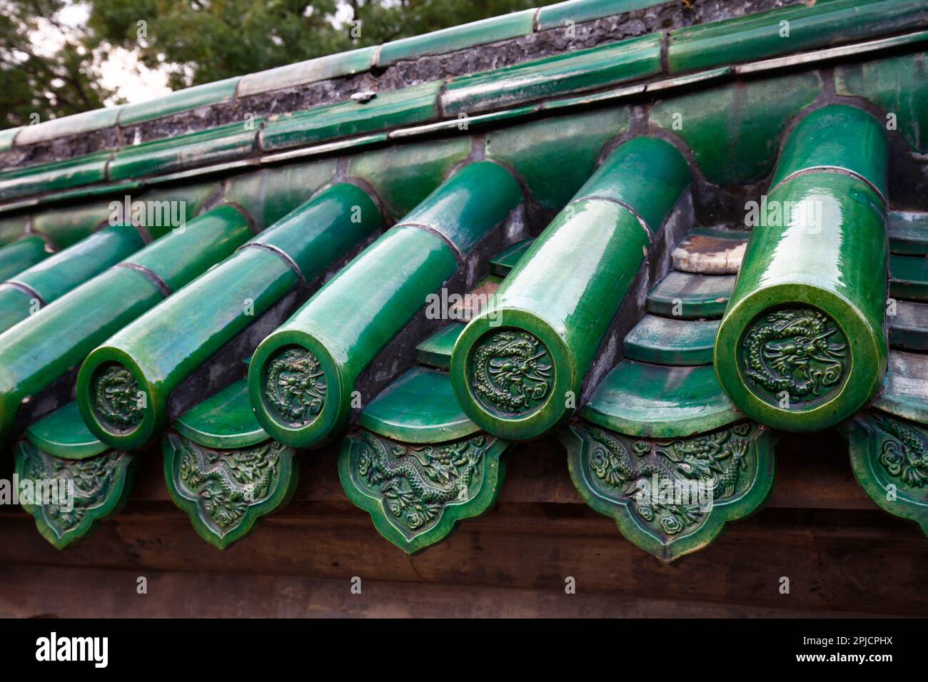 On the wall green glazed tiles as the background, the traditional ...