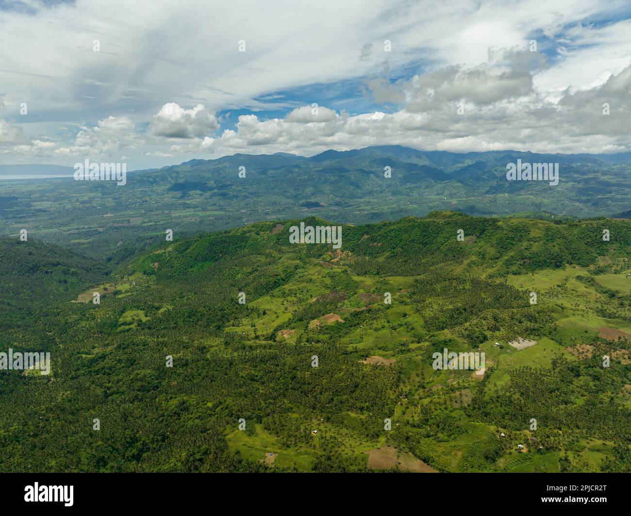Aerial drone of slopes of mountains and hills with forest and farmland ...