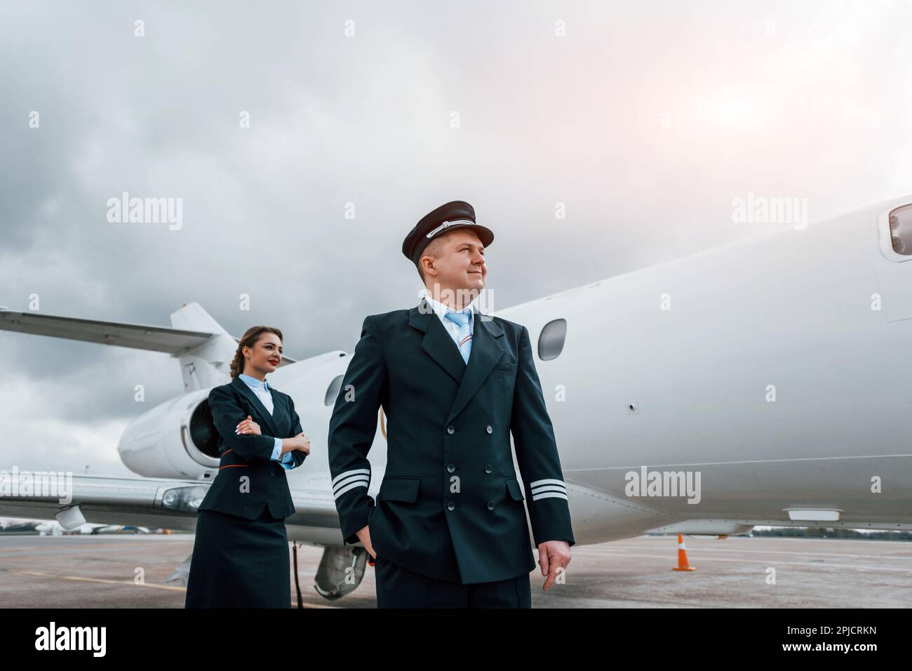 Man with woman. Aircraft crew in work uniform is together outdoors near ...