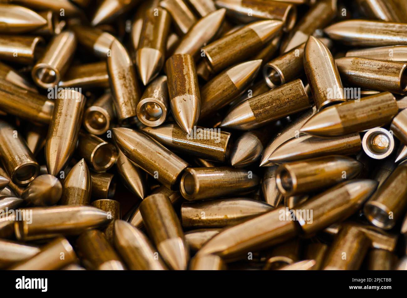 Scattered grey bullets armour ammunition as background Stock Photo - Alamy