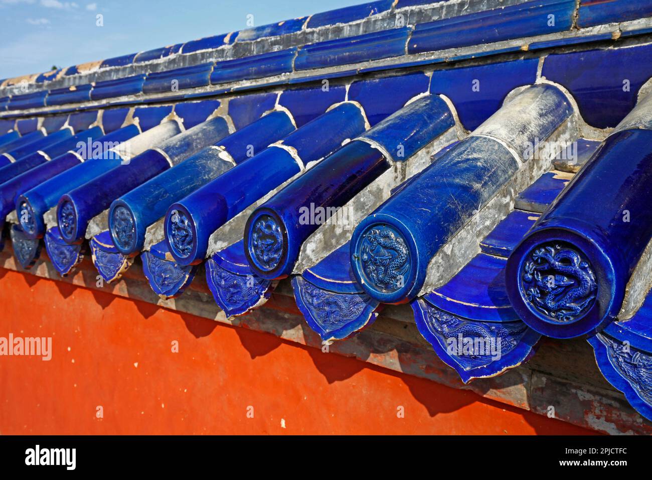 The blue glazed tiles on the wall as the background, the traditional ...