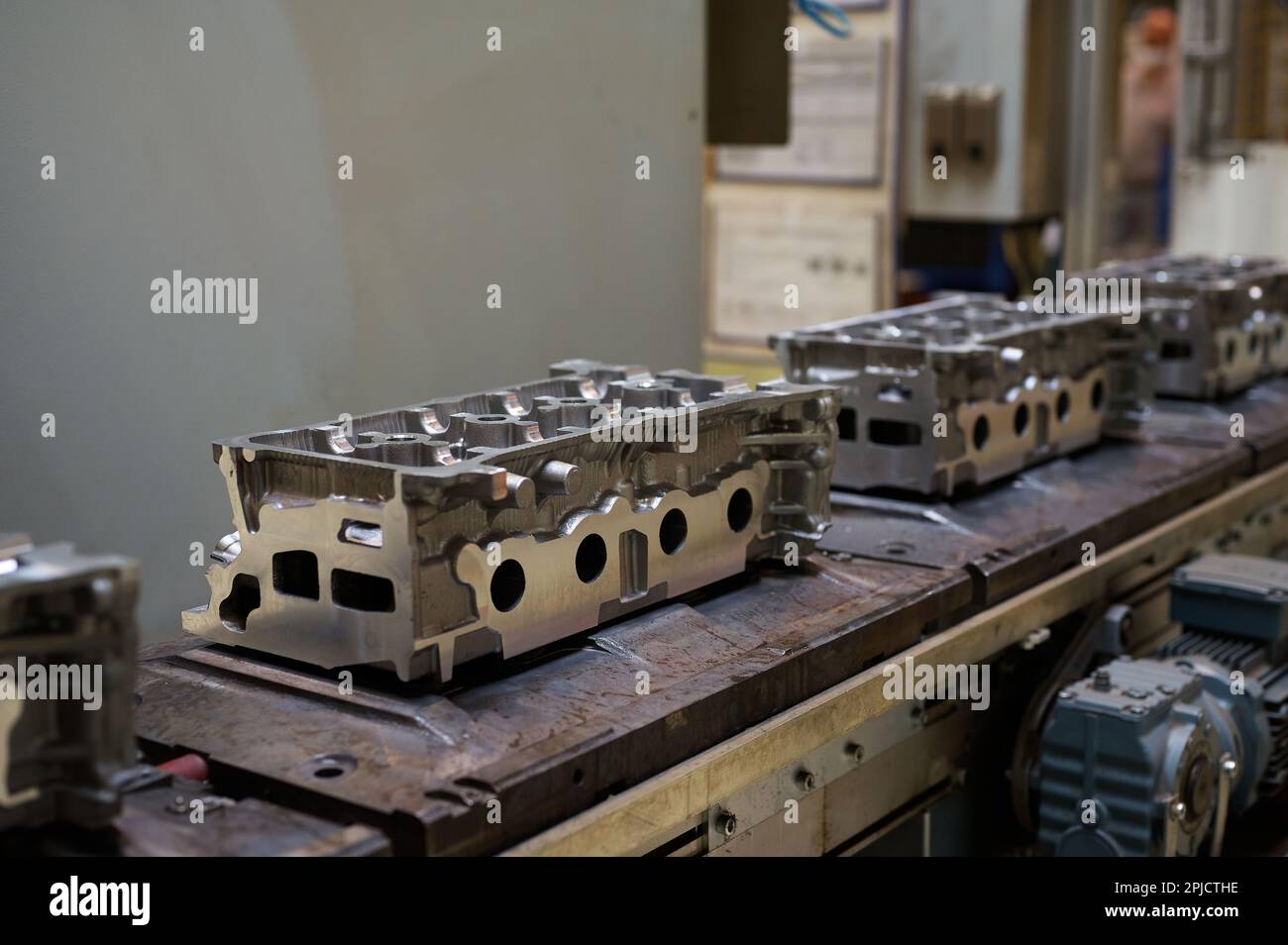 Car engine cylinder heads in housings on conveyor in shop Stock Photo ...