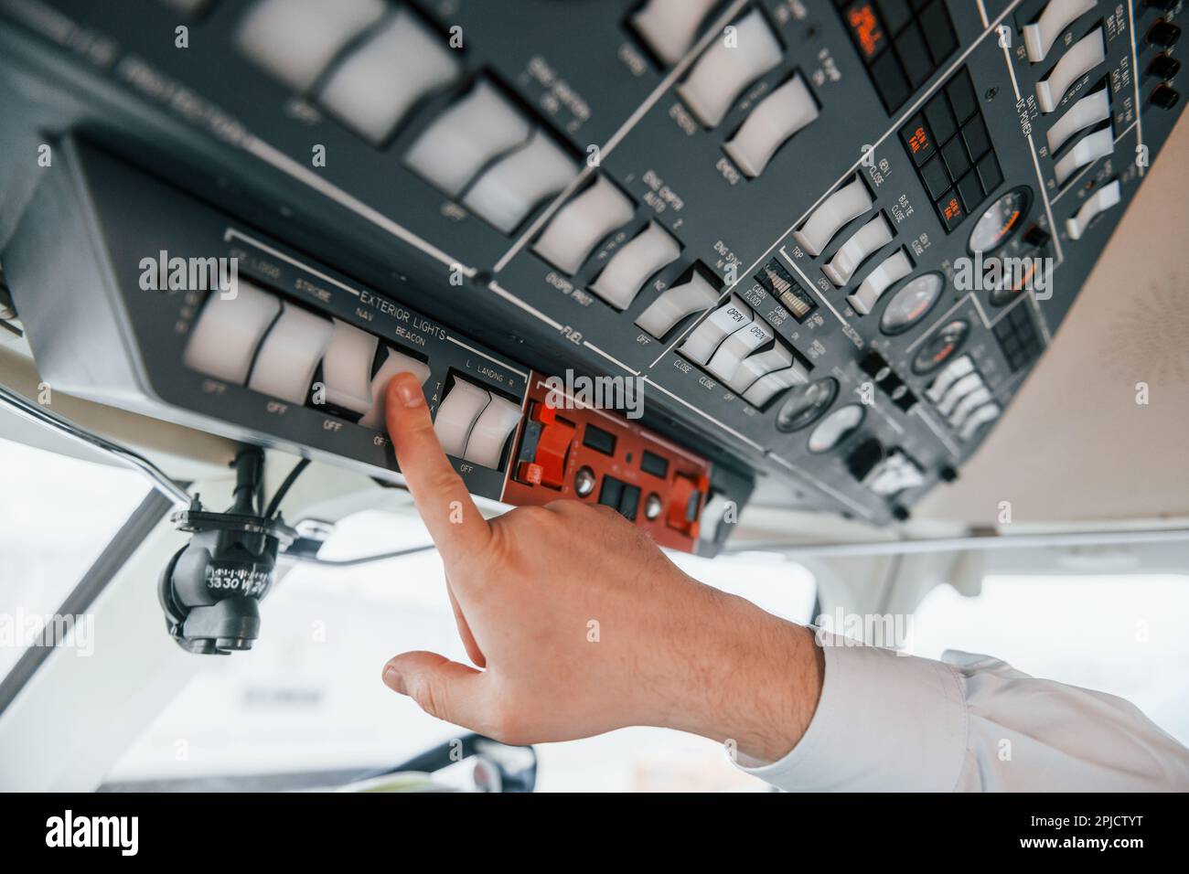 Close up view. Pilot on the work in the passenger airplane. Preparing ...