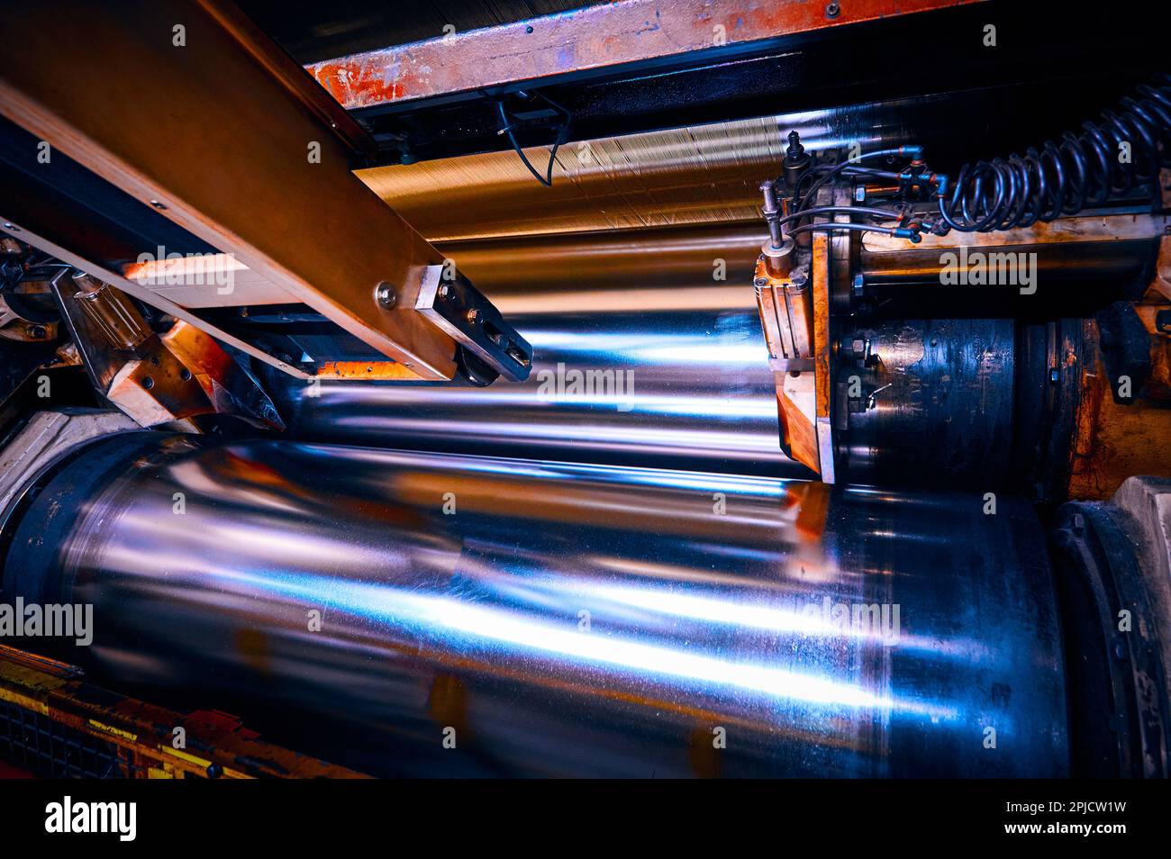 Shiny metal roller and steel cable processing in workshop Stock Photo ...