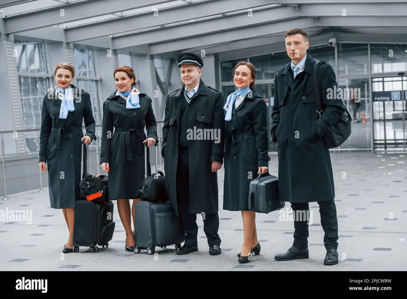 Aircraft crew in work uniform is together outdoors in the airport Stock ...