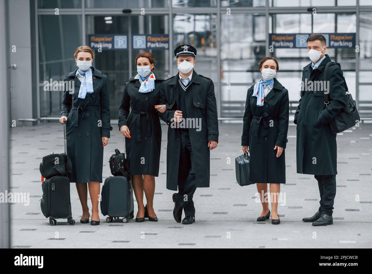 Aircraft crew in work uniform is together outdoors in the airport Stock ...