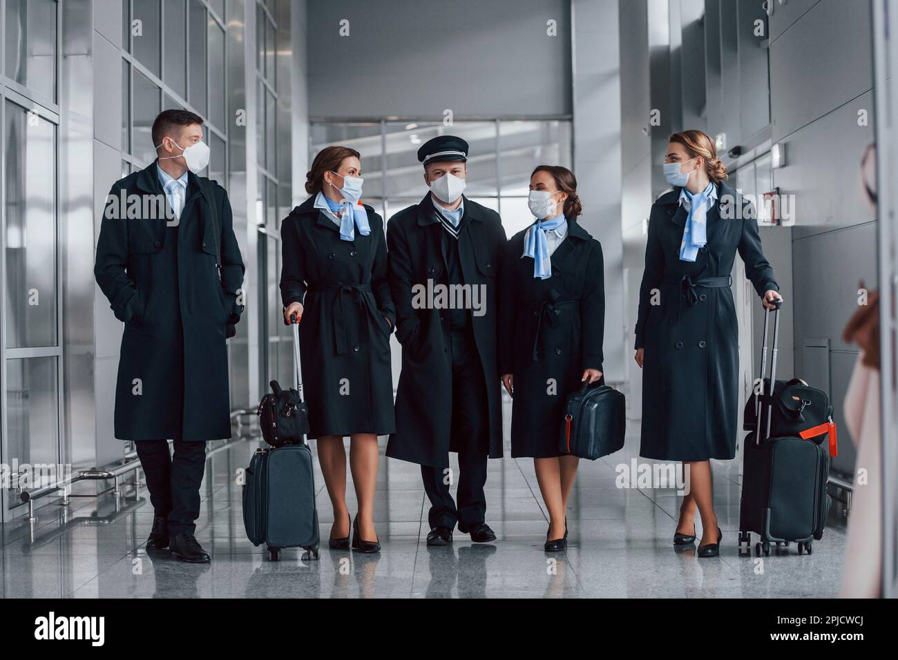 Aircraft crew in work uniform is together outdoors in the airport Stock ...