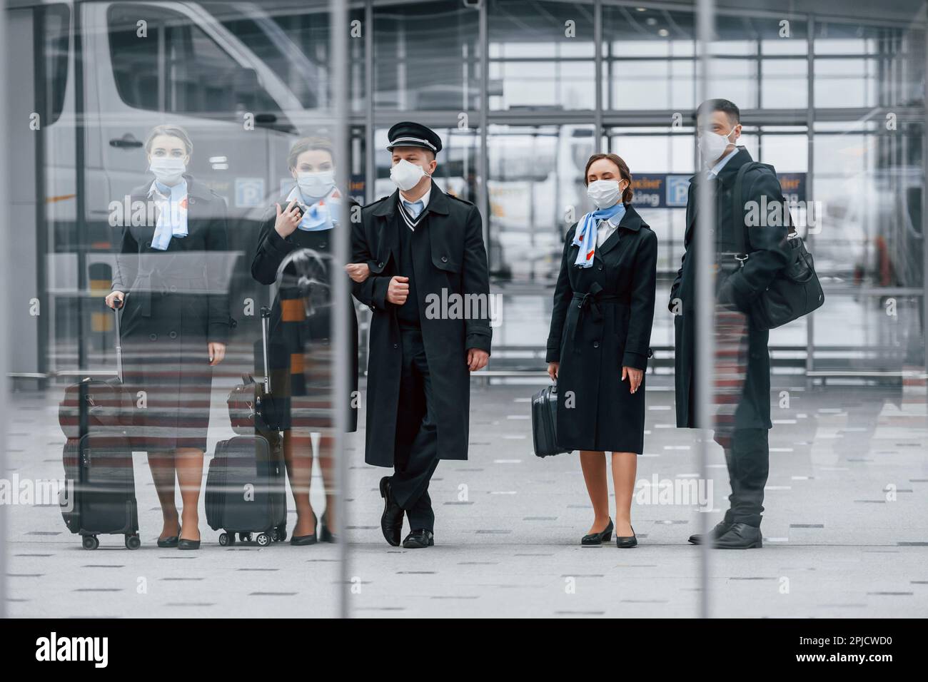 Aircraft crew in work uniform is together outdoors in the airport Stock ...