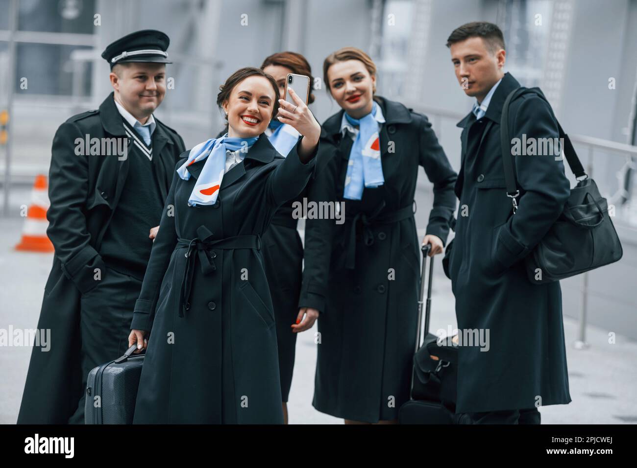 Aircraft crew in work uniform is together outdoors in the airport Stock ...