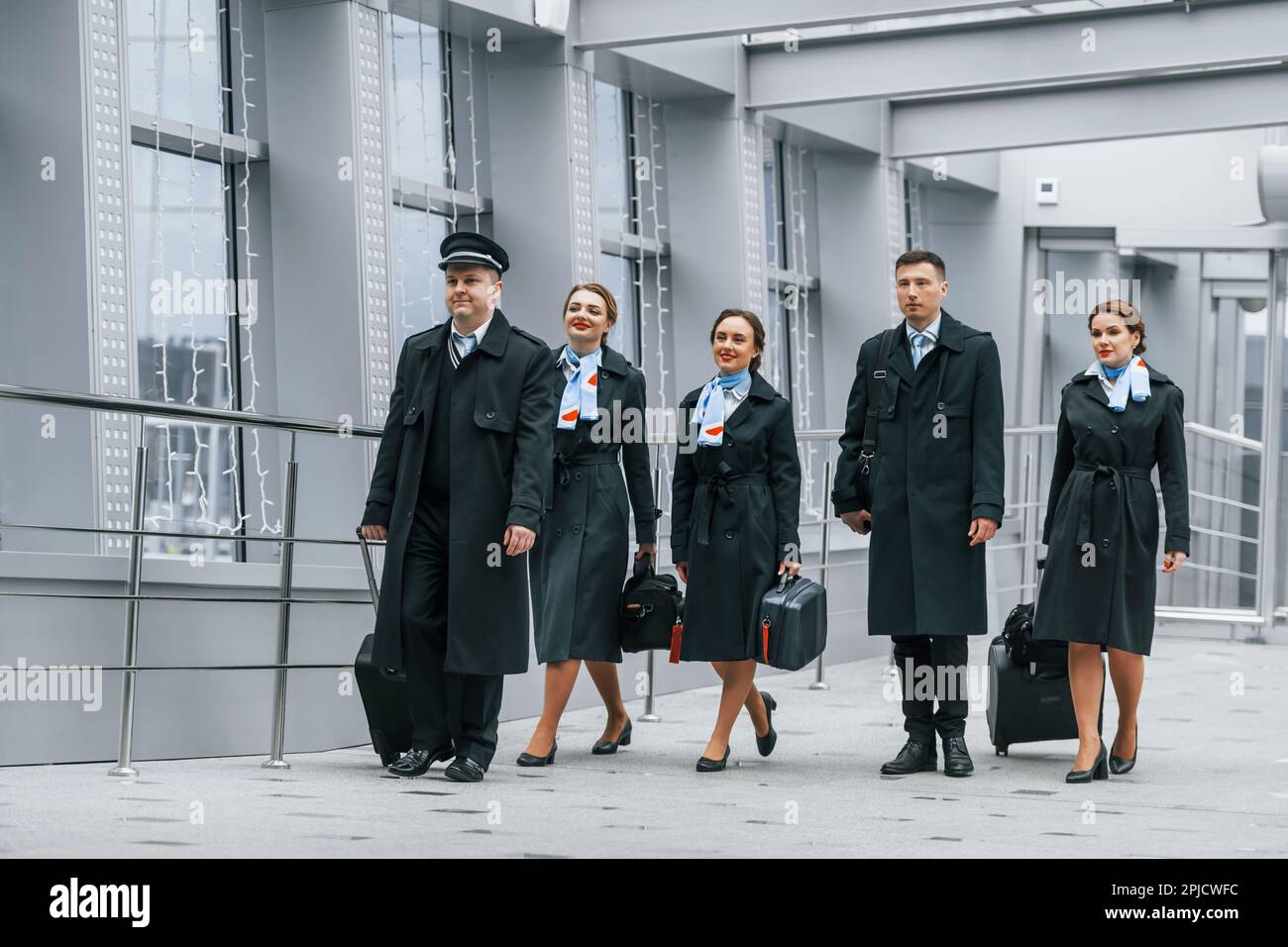 Aircraft crew in work uniform is together outdoors in the airport Stock ...