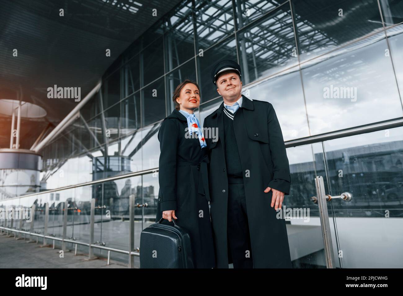Man with woman. Aircraft crew in work uniform is together outdoors in ...