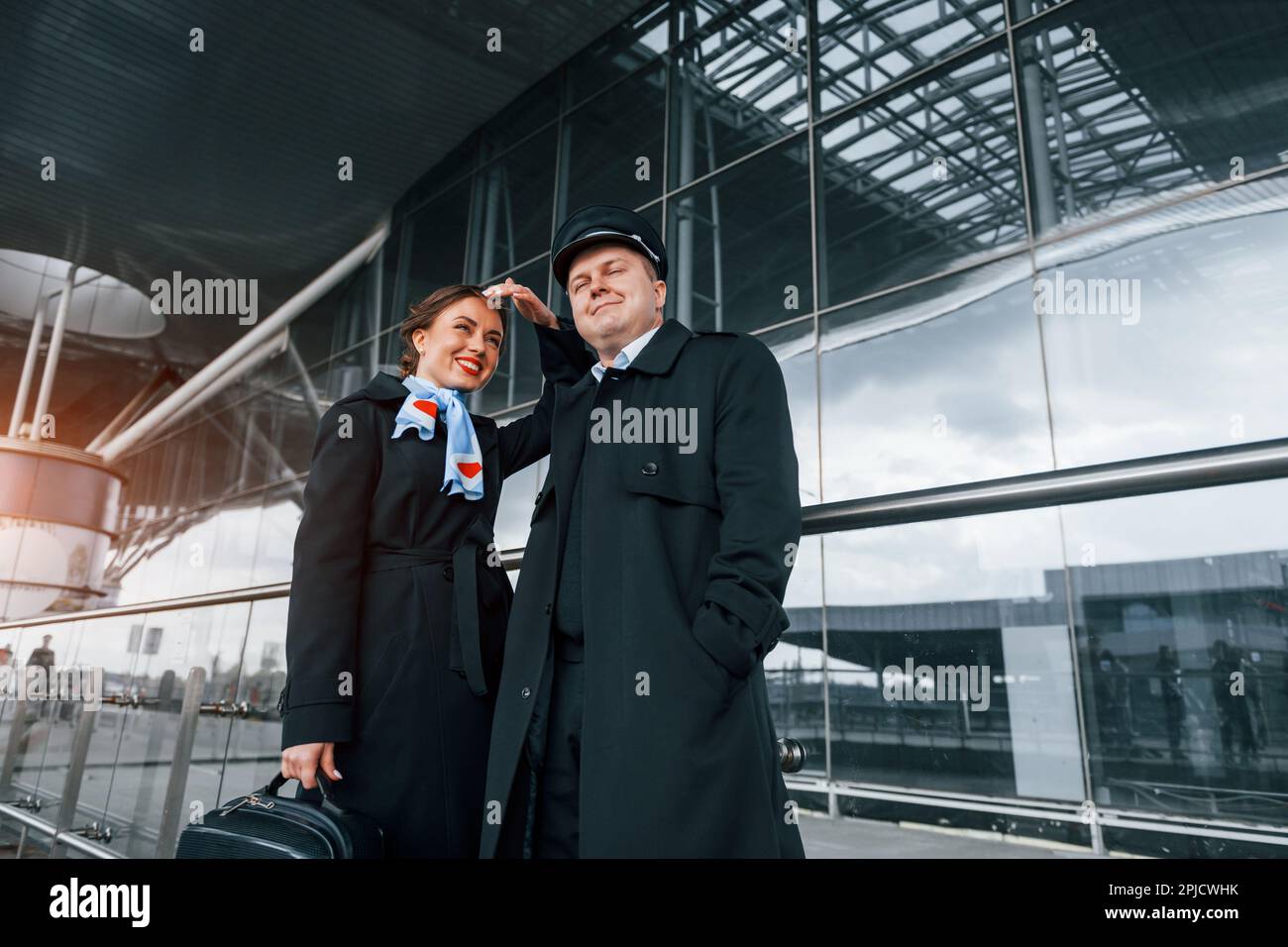 Man with woman. Aircraft crew in work uniform is together outdoors in ...