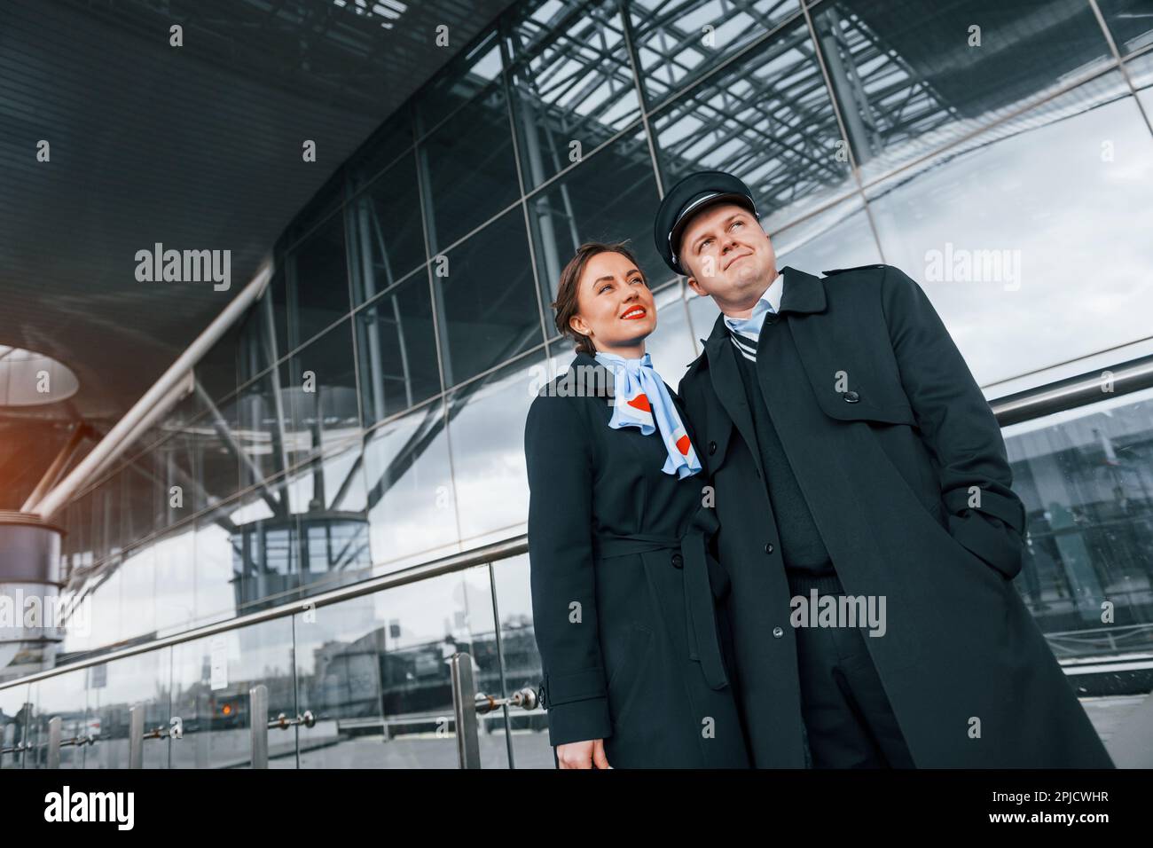 Man with woman. Aircraft crew in work uniform is together outdoors in ...
