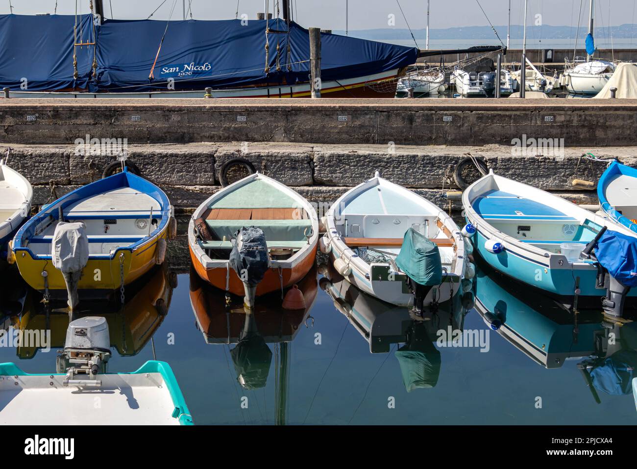 Bardolino, Lake Garda, Italy - 29 March 2023 Colorful fishing boats at ...