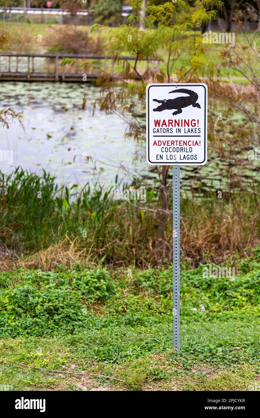 A sign in West Palm Beach, Florida warning of alligators in the lake ...